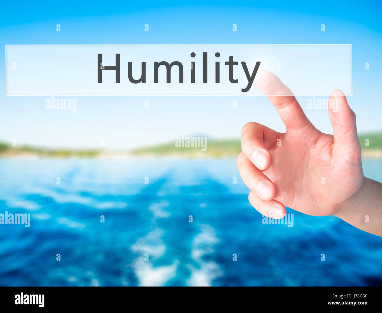 Humility - Hand pressing a button on blurred background concept ...