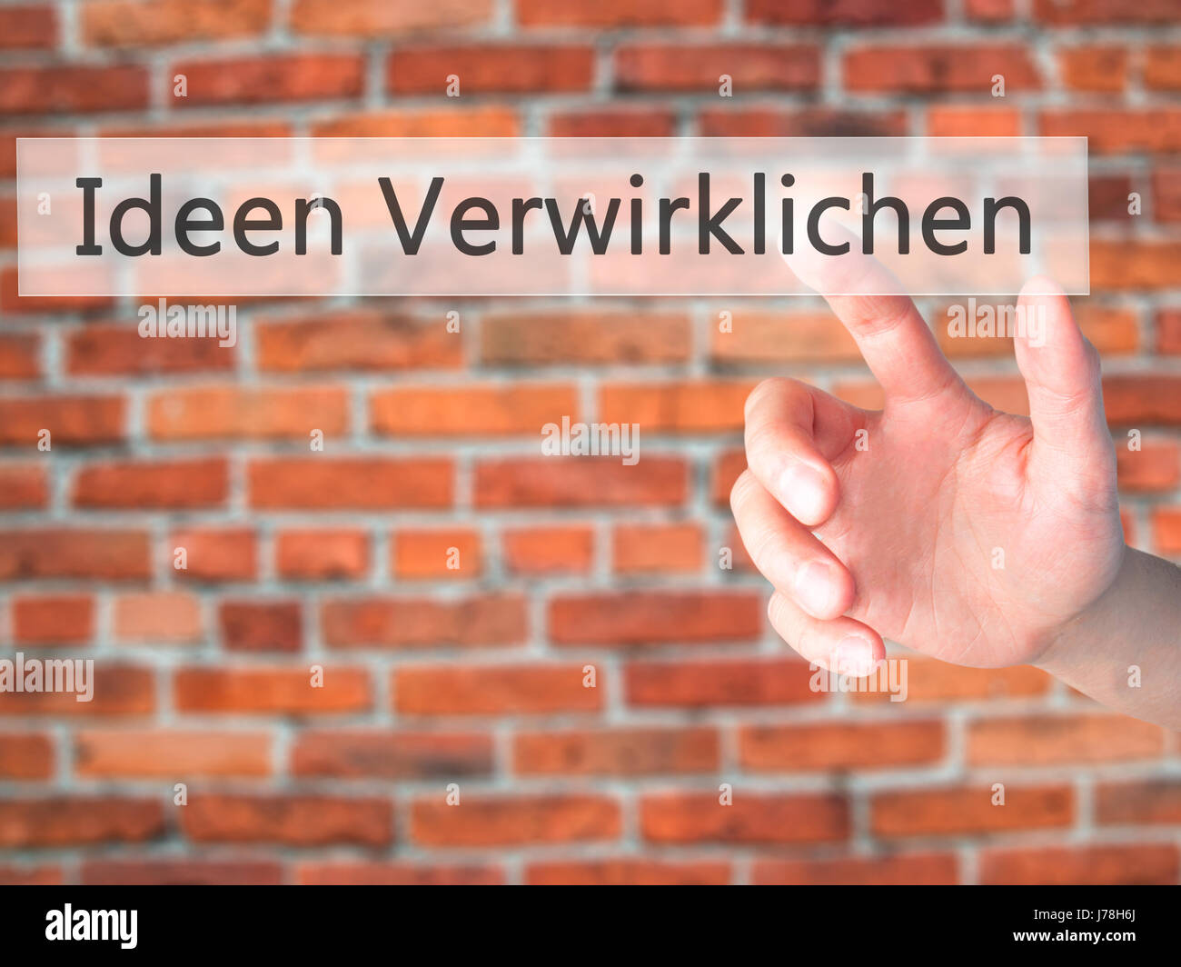 Ideen Verwirklichen ( Realize Ideas in German) - Hand pressing a button ...