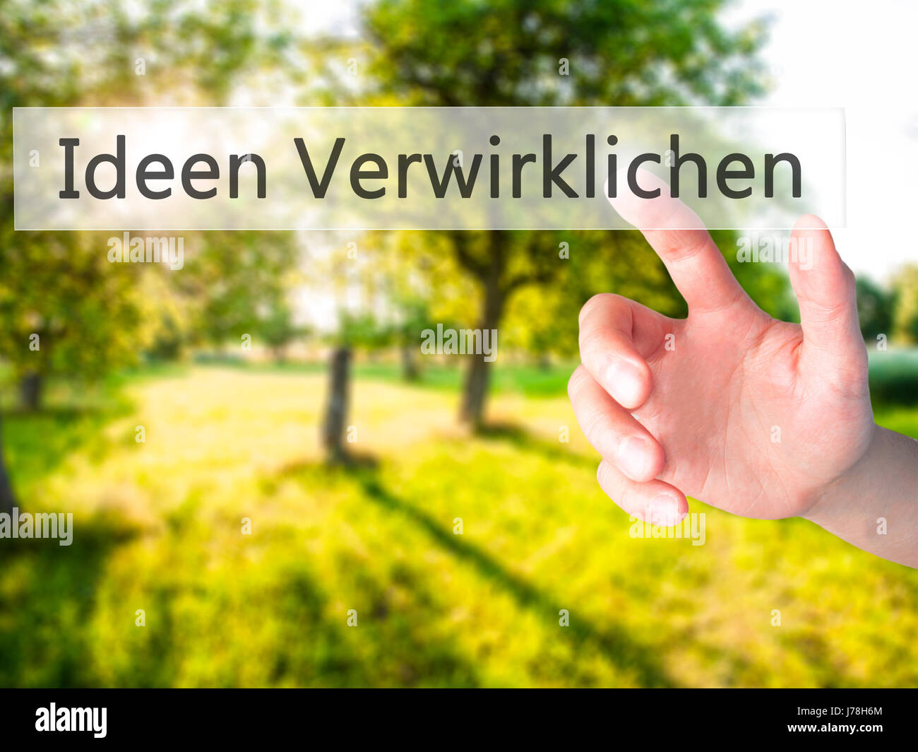 Ideen Verwirklichen ( Realize Ideas in German) - Hand pressing a button ...