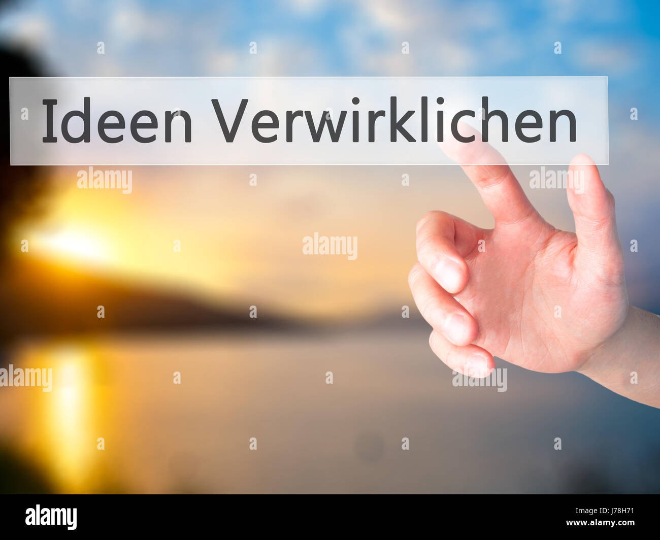 Ideen Verwirklichen ( Realize Ideas in German) - Hand pressing a button ...