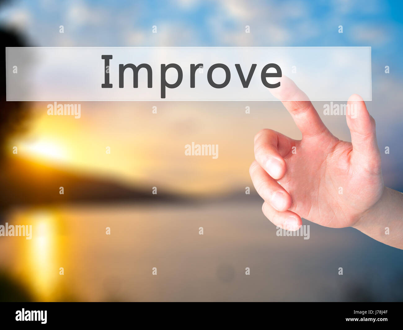 Improve - Hand pressing a button on blurred background concept ...