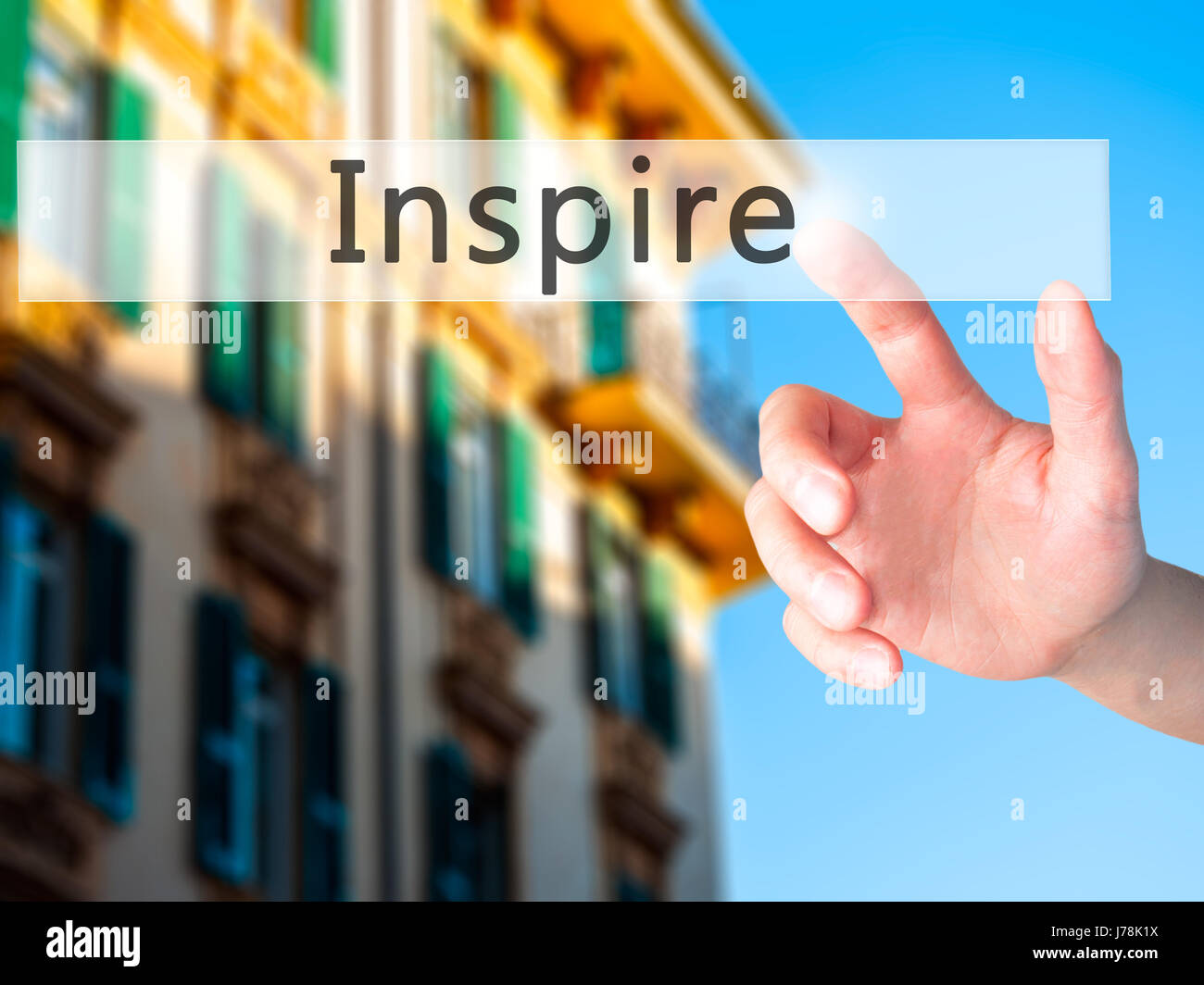Inspire - Hand pressing a button on blurred background concept ...