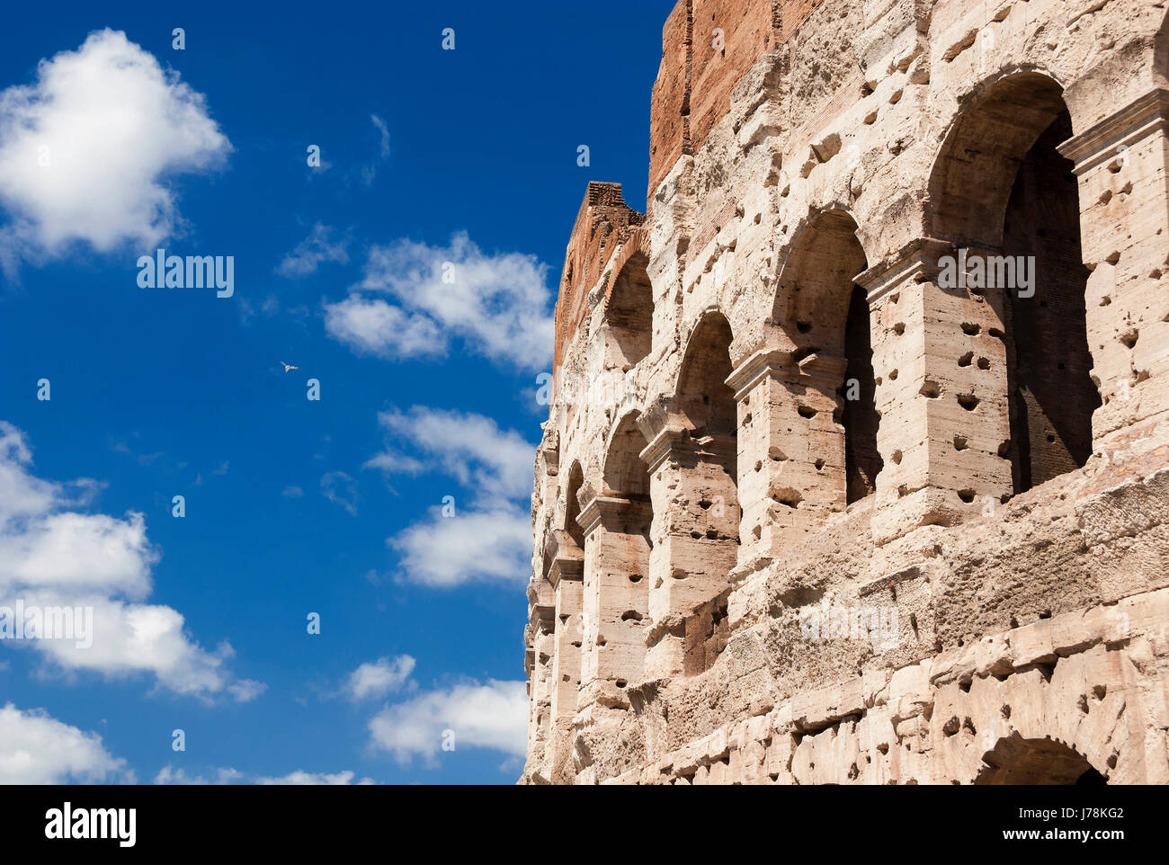 Coliseum monumental arcades with blue sky in Rome Stock Photo - Alamy