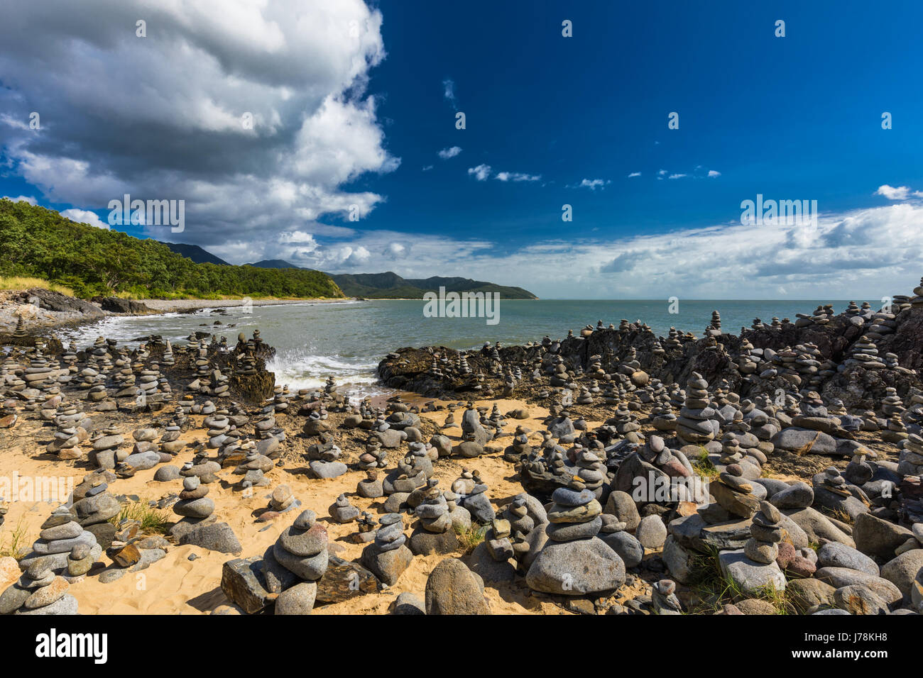 Stacked balancing rocks on the beach between Cairns and Port Douglas ...