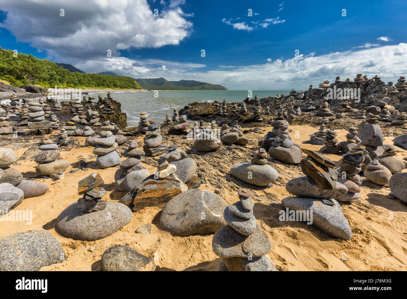 Stacked balancing rocks on the beach between Cairns and Port Douglas ...