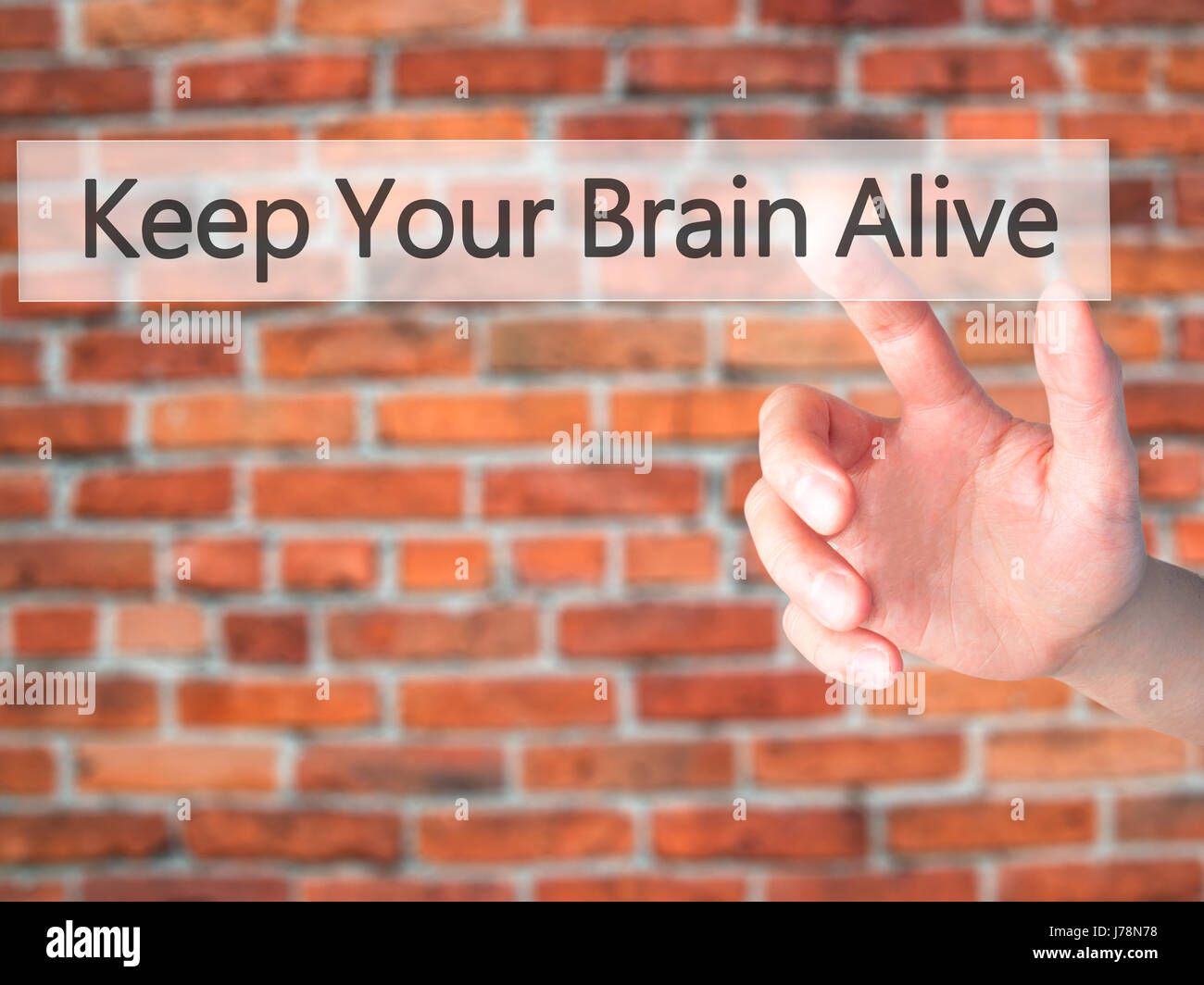 Keep Your Brain Alive - Hand pressing a button on blurred background ...