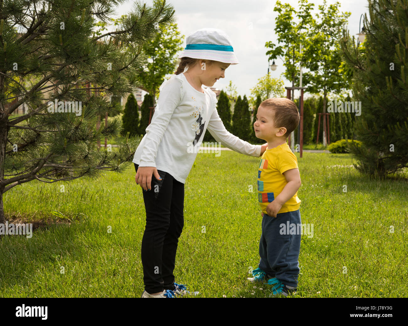 little kids playing on the lawn Stock Photo - Alamy