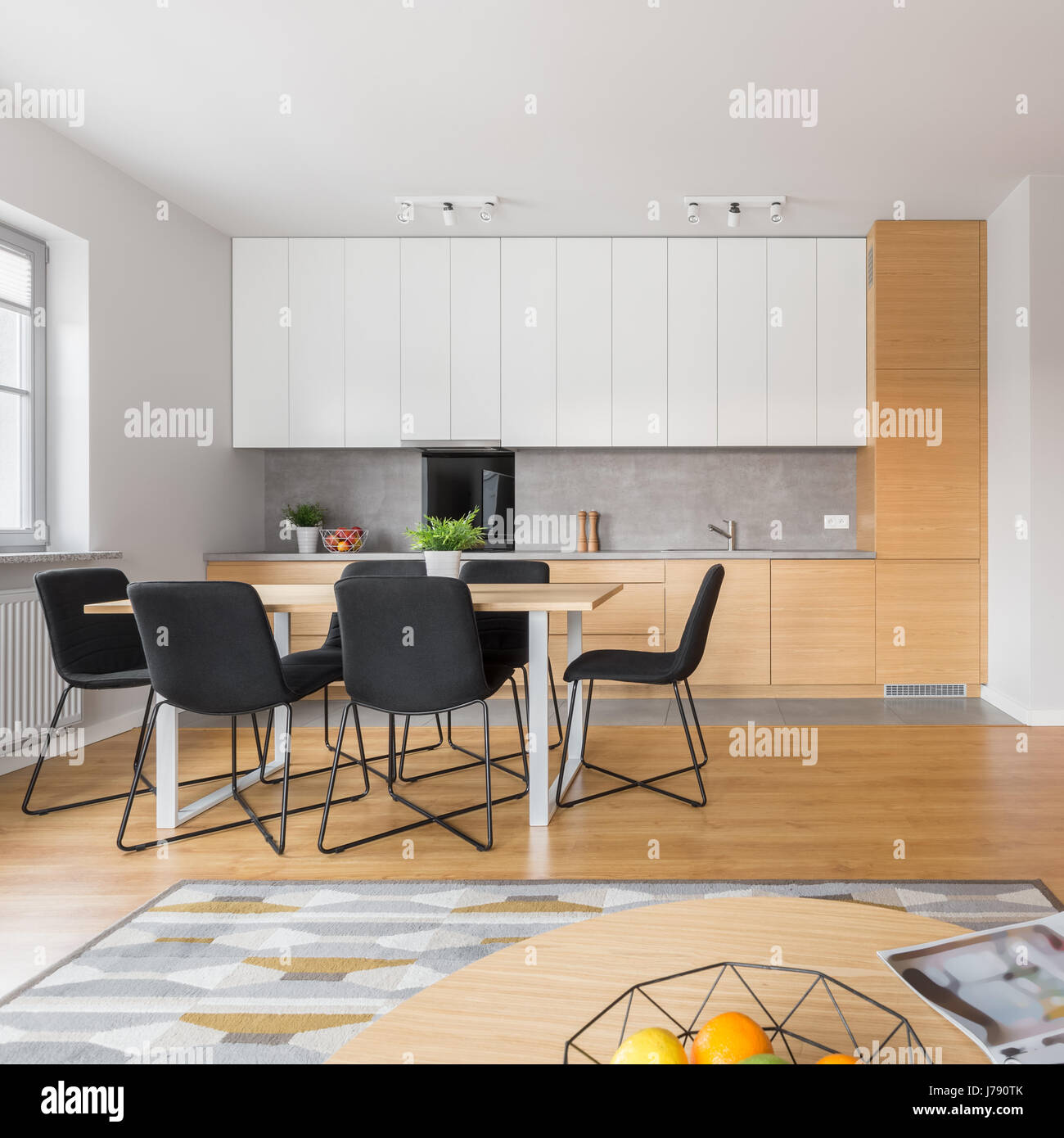 Luxury open space kitchen with big table and black chairs Stock Photo ...