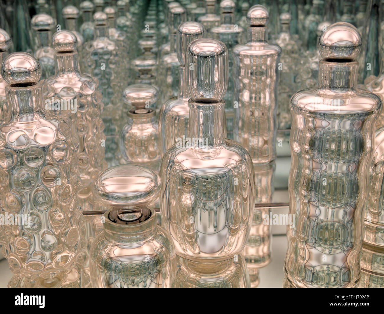 Abstract display of reflective glass bottles in a mirrored room ...
