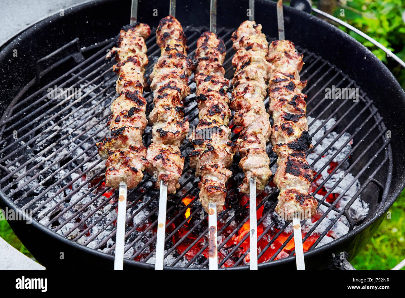 Barbecue skewers meat kebabs on a grill, selective focus Stock Photo ...