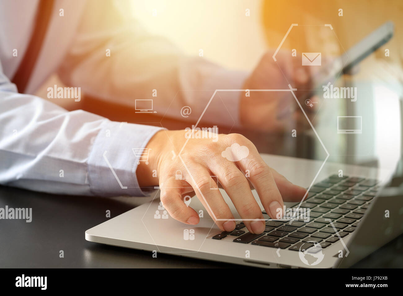 close up of businessman working with mobile phone and laptop computer ...
