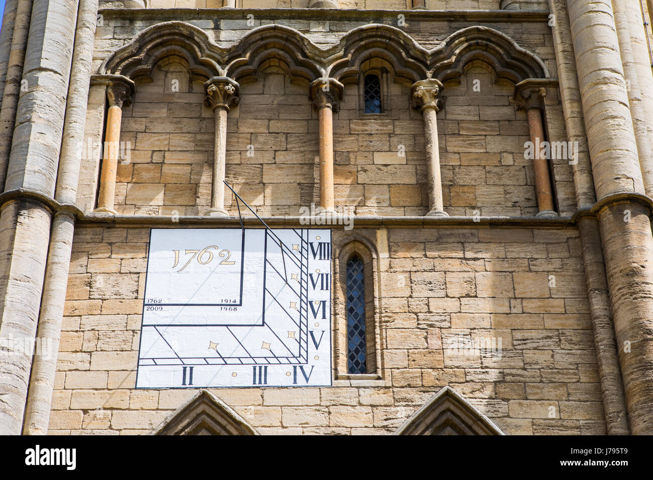 A sun dial on the facade of the historic Peterborough Cathedral in ...