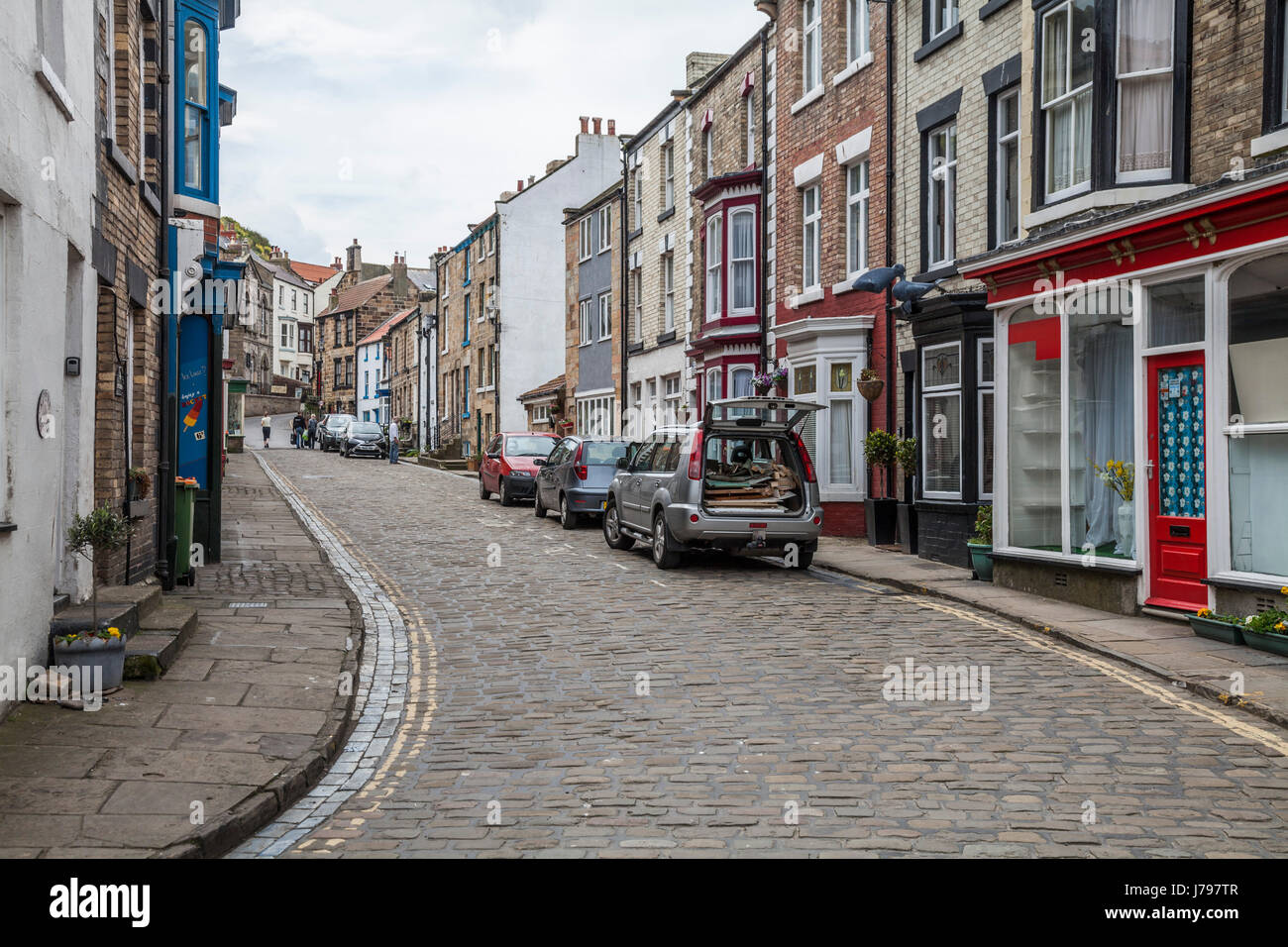 People walking along the narrow cobbled streets in Staithes, North ...