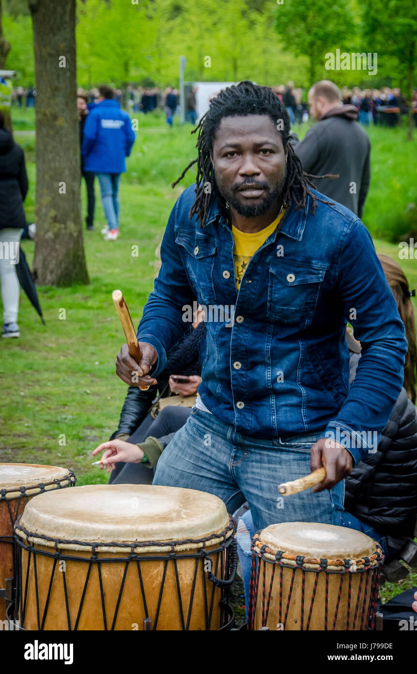 African man on the drum during festival Stock Photo - Alamy