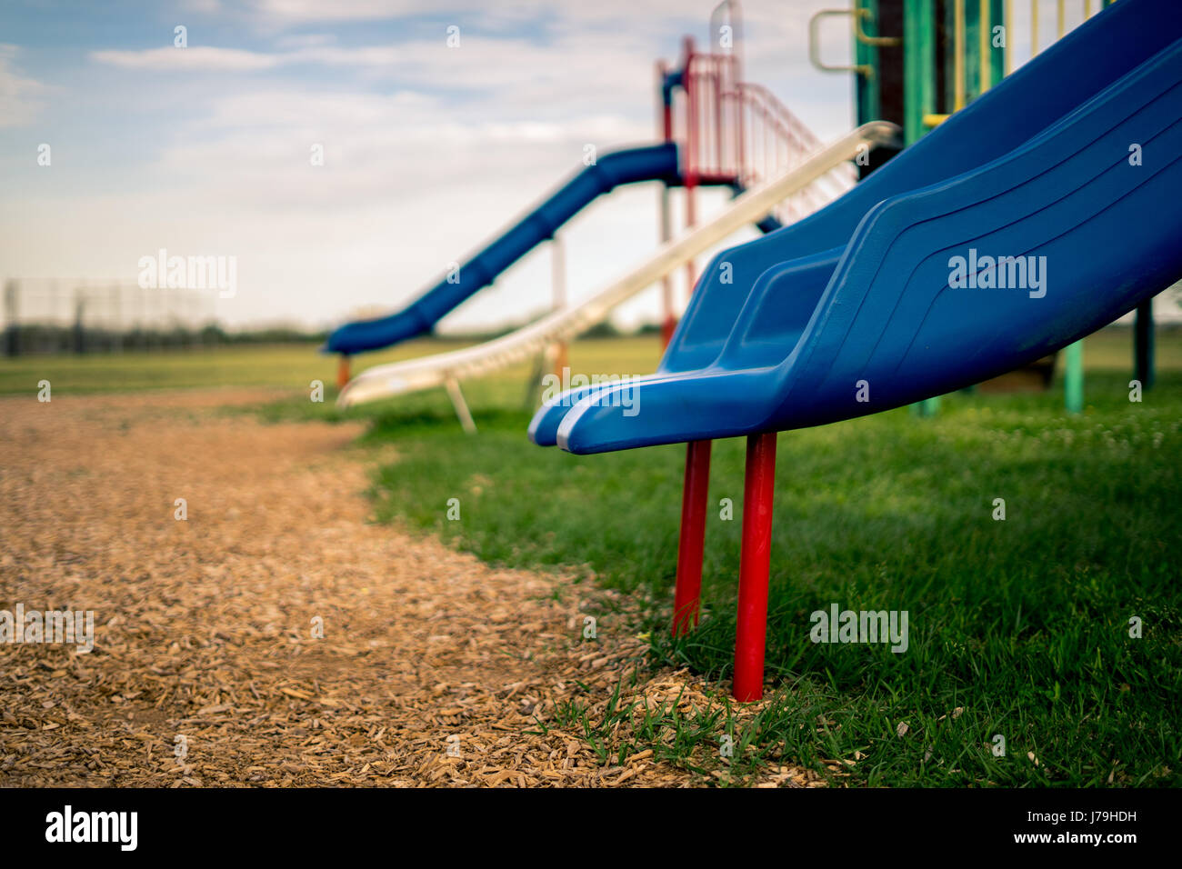 Playground slide in a summer park Stock Photo - Alamy