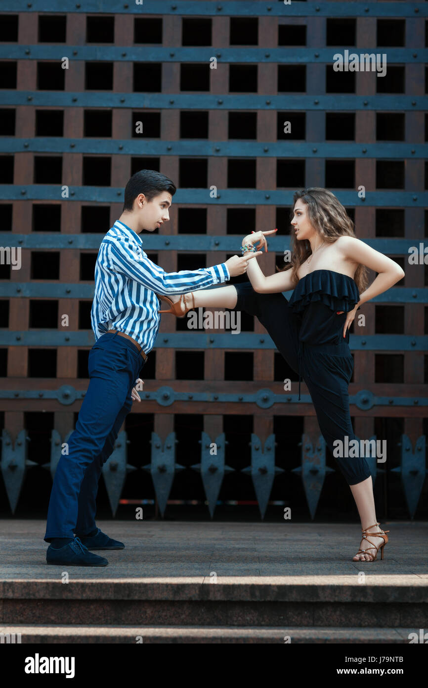 In a passionate dance dancer she puts her foot on his chest partner ...