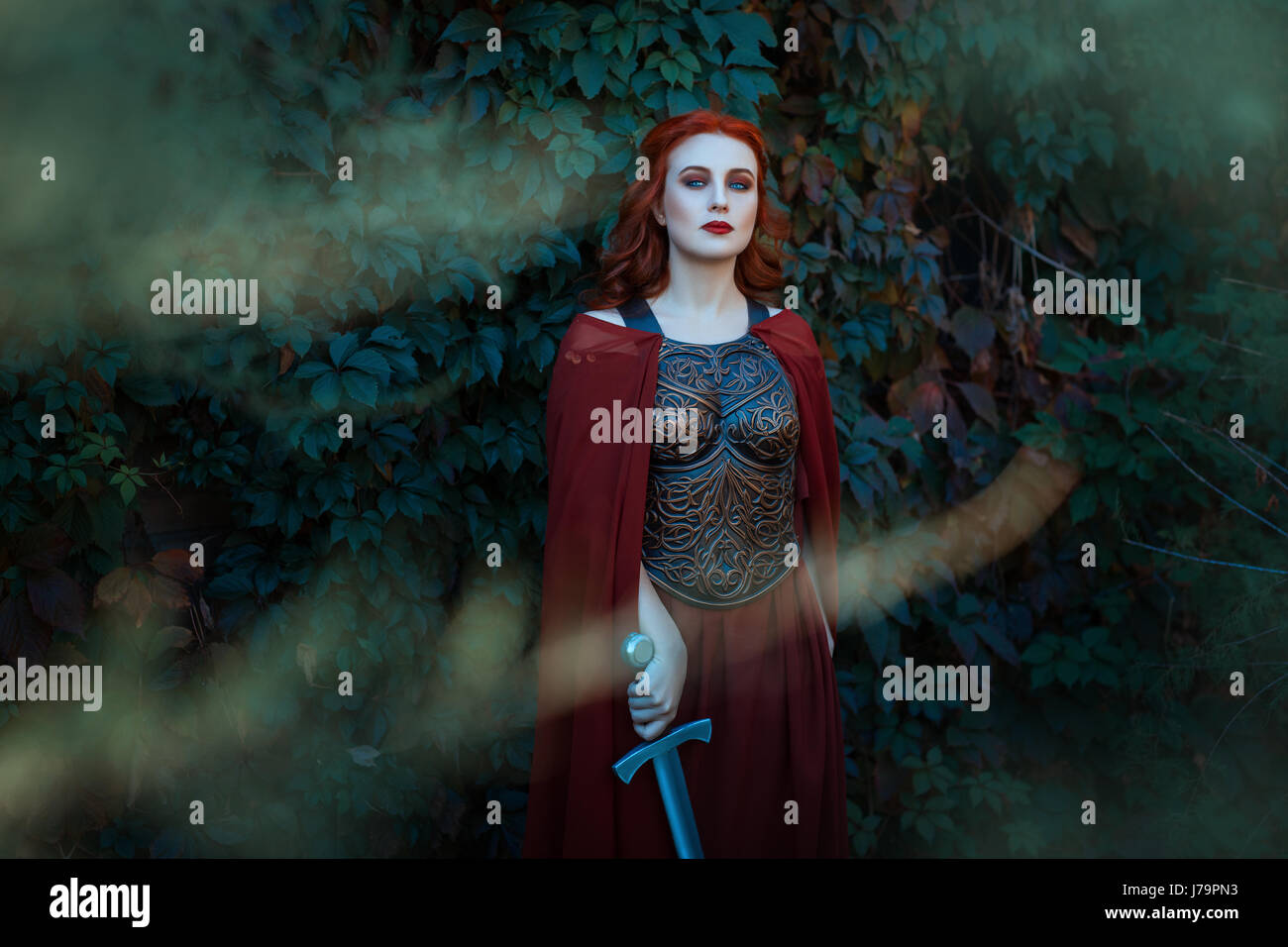 Beautiful girl with a sword standing and looking. Gothick style Stock ...