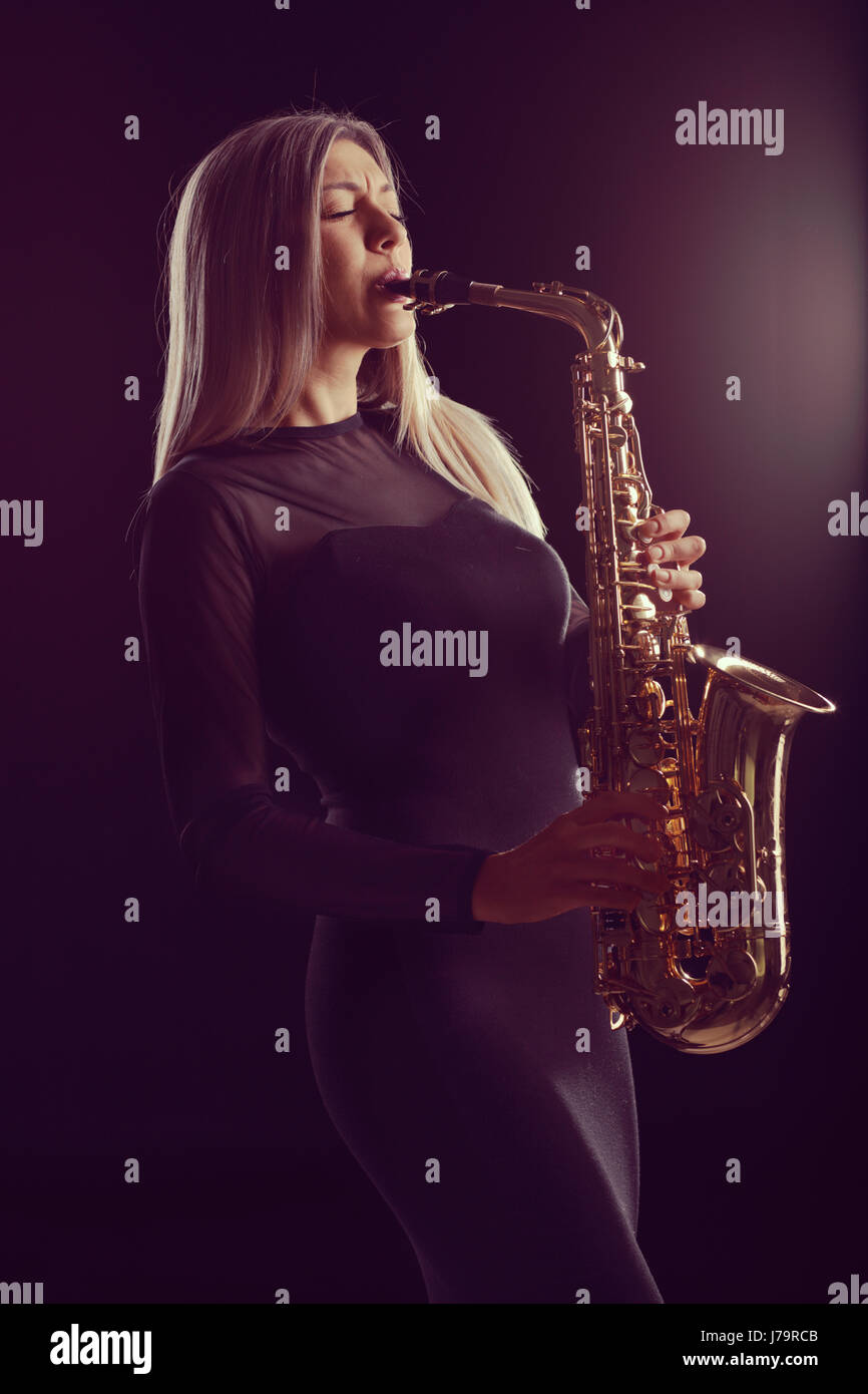 Female jazz musician performing on a saxophone Stock Photo - Alamy
