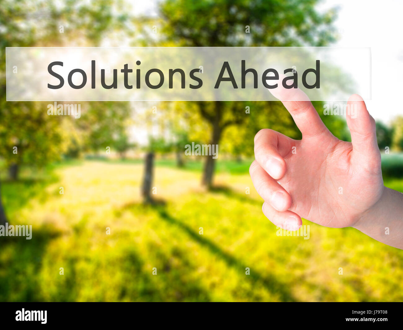 Solutions Ahead - Hand pressing a button on blurred background concept ...