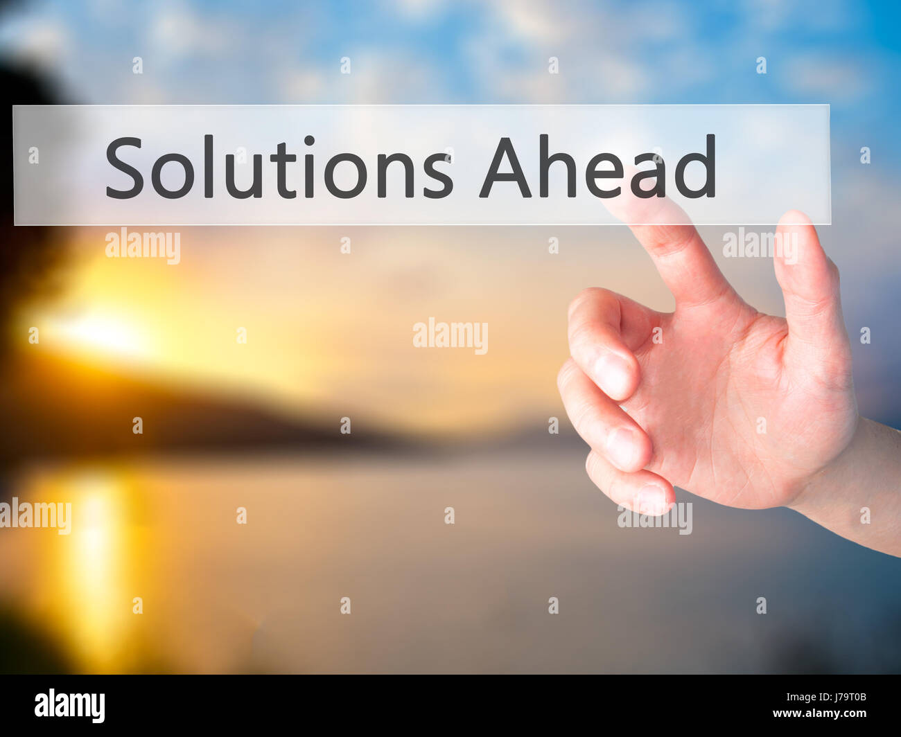 Solutions Ahead - Hand pressing a button on blurred background concept ...