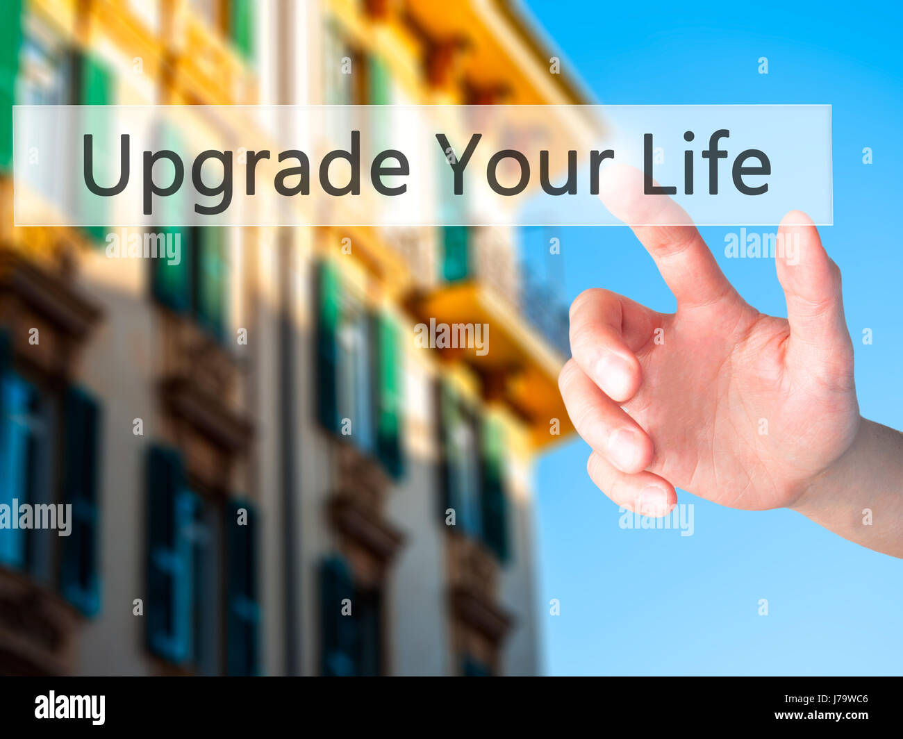 Upgrade Your Life - Hand pressing a button on blurred background ...