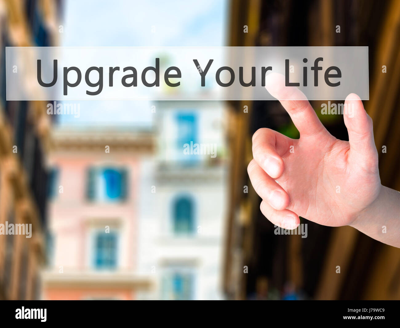 Upgrade Your Life - Hand pressing a button on blurred background ...