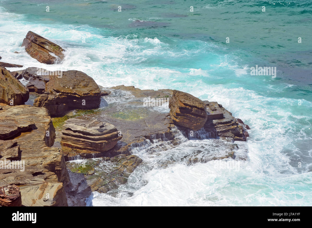 Waves crashing over sandstone rock platforms on NSW coast at Garie ...