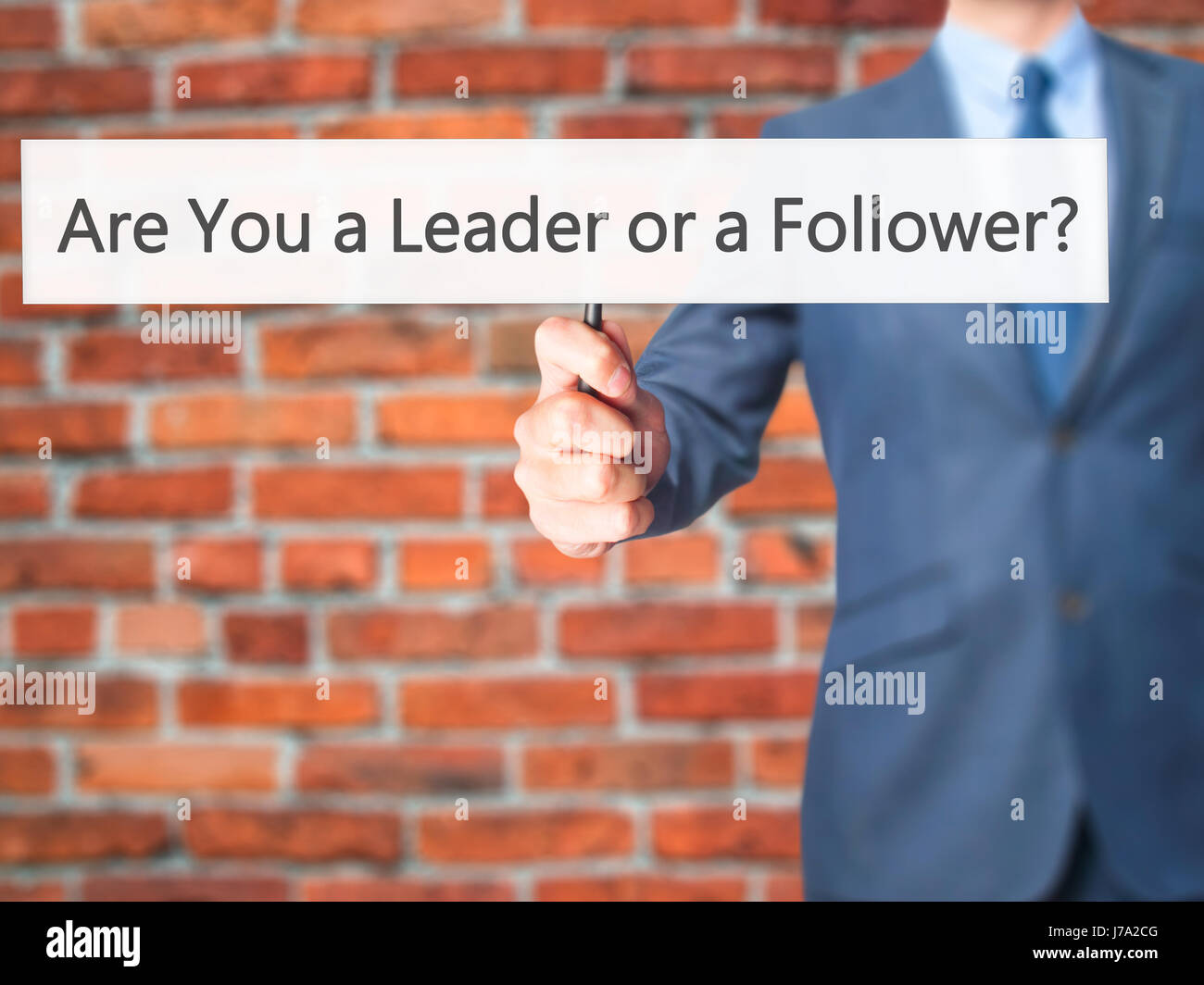 Are You a Leader or a Follower ? - Business man showing sign. Business ...