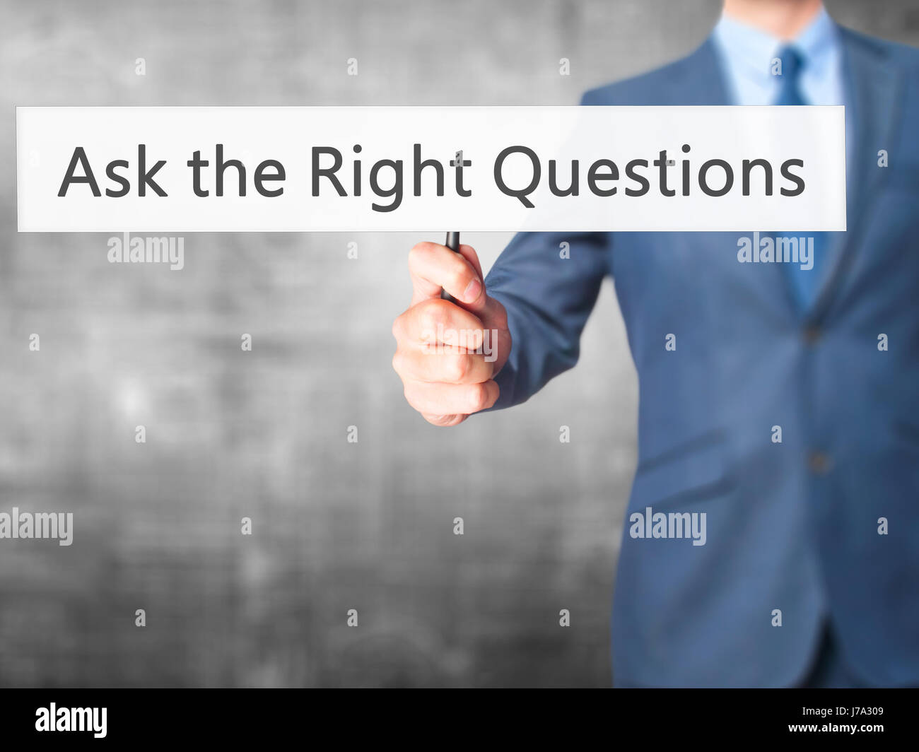 Ask the Right Questions - Business man showing sign. Business ...