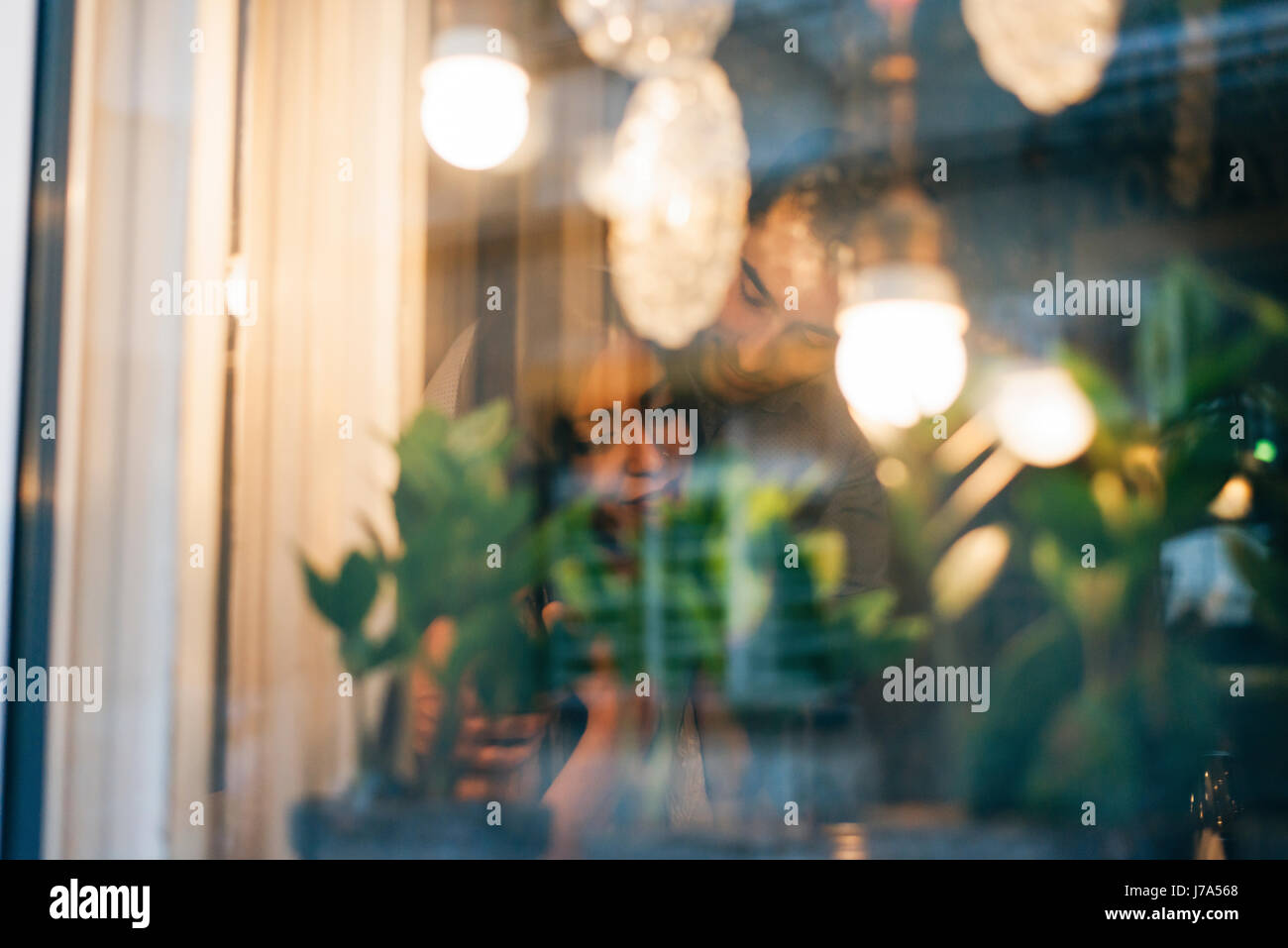 Couple in love behind window pane Stock Photo - Alamy