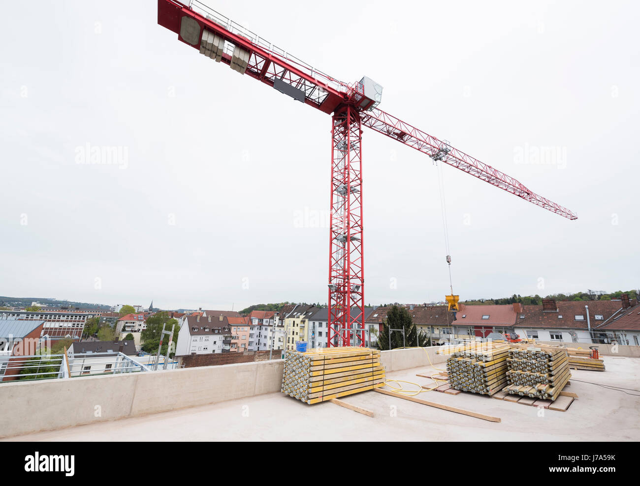 Crane on rooftop on construction site Stock Photo - Alamy