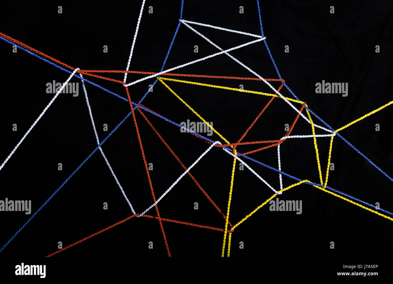 Connected threads in front of black background Stock Photo - Alamy
