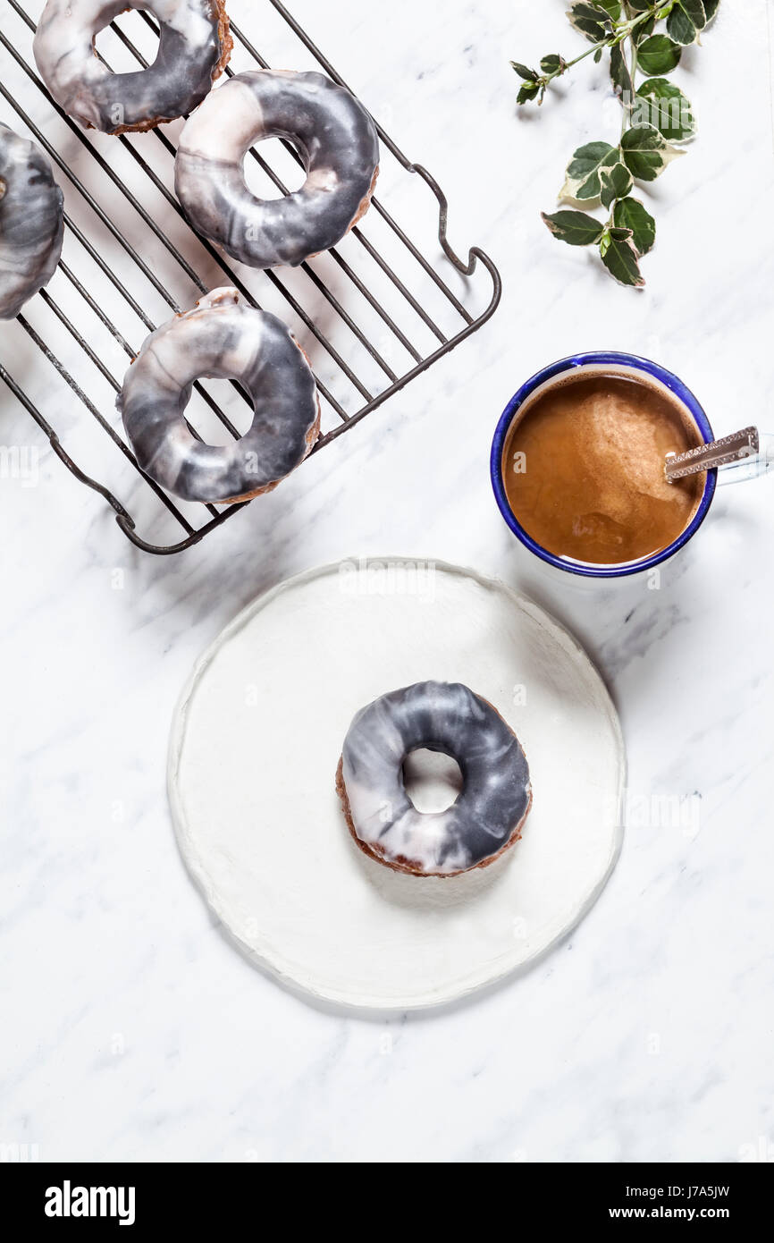 Homemade marble-glazed donuts and coffee Stock Photo - Alamy