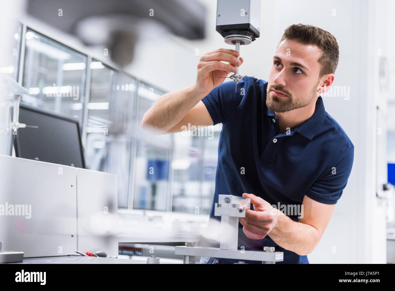 Man adjusting machine in testing instrument room Stock Photo - Alamy