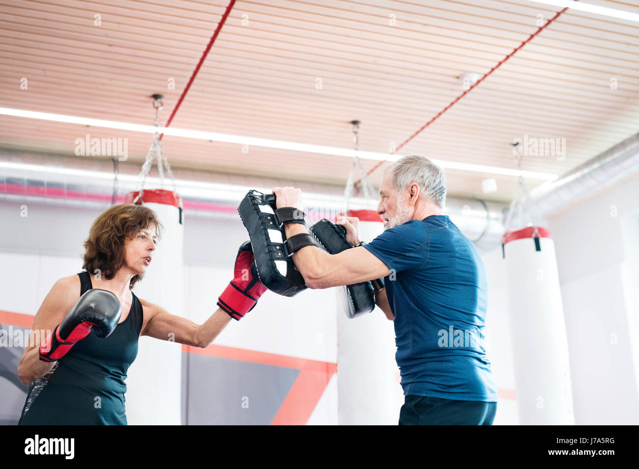 Fit senior woman boxing with her coach Stock Photo - Alamy