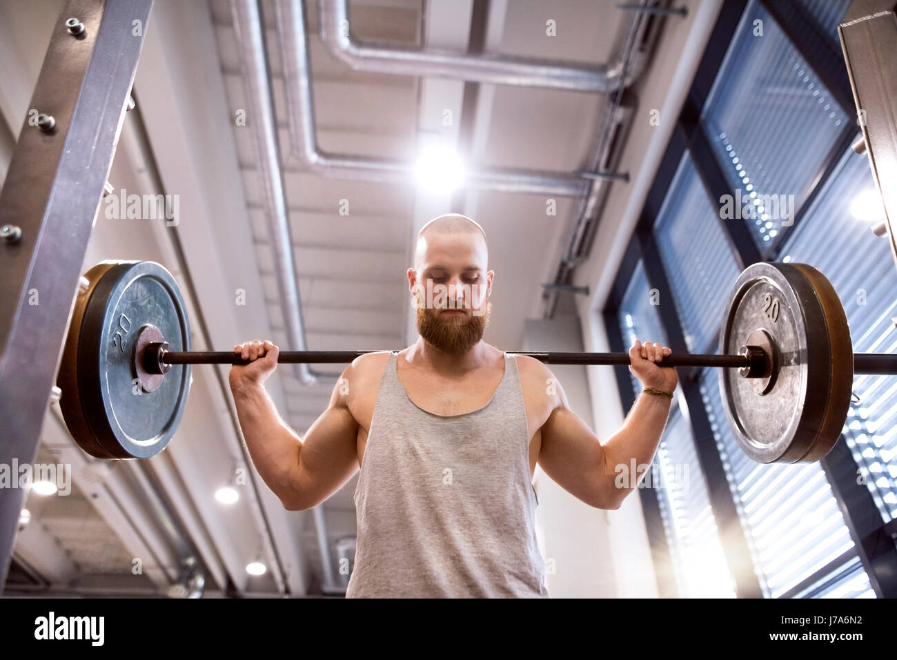 Young man exercising weight lifting Stock Photo - Alamy