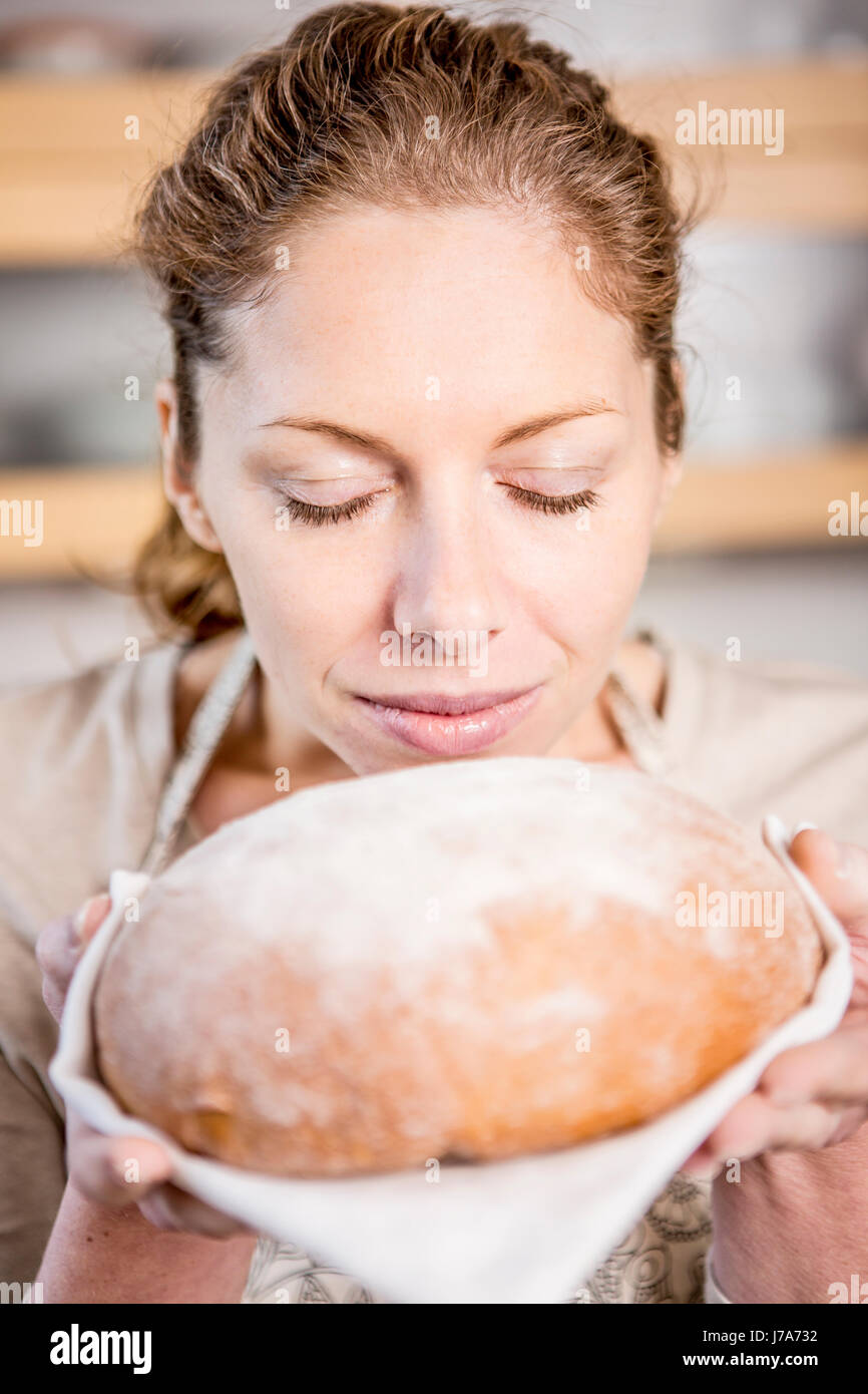 Woman holding loaf of bread Stock Photo - Alamy