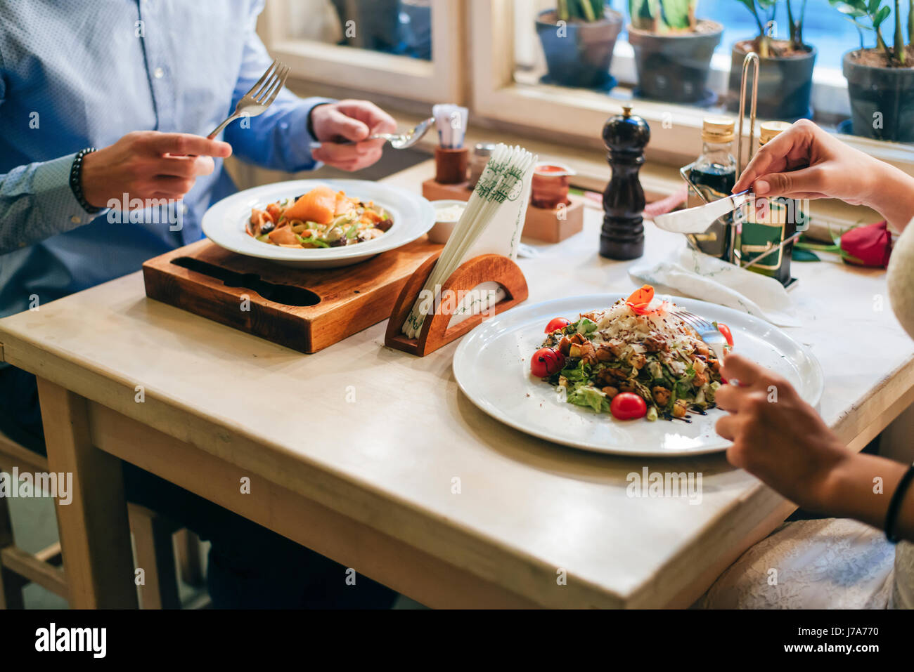 Couple having dinner in a restaurant, partial view Stock Photo - Alamy