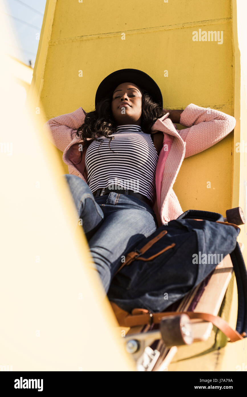 Young woman sitting on bridge Stock Photo - Alamy