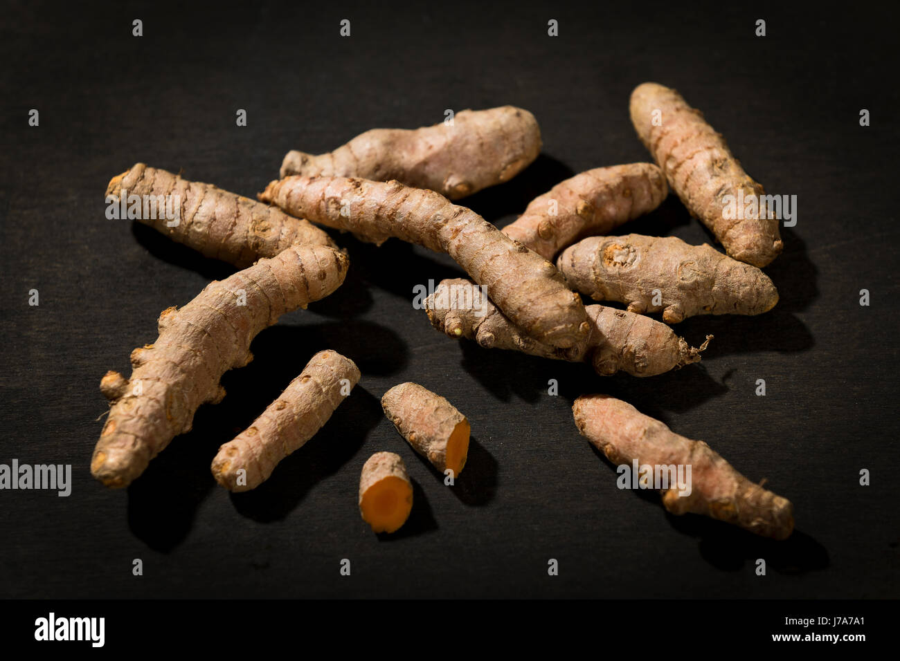Fresh curcuma on dark wood Stock Photo - Alamy