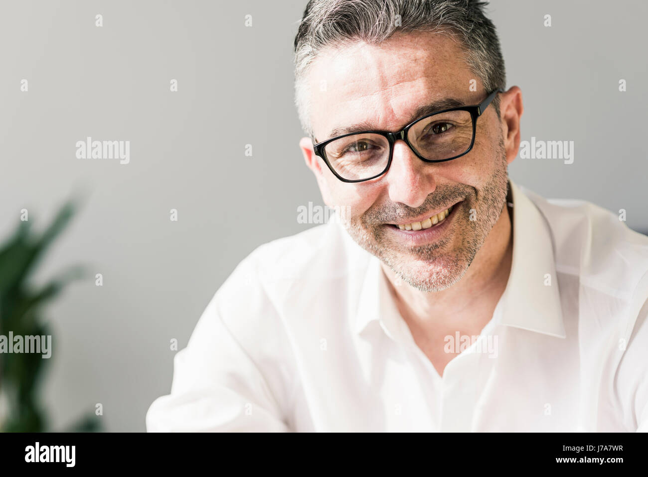 Portrait Of Smiling Businessman With Stubble Wearing Glasses Stock