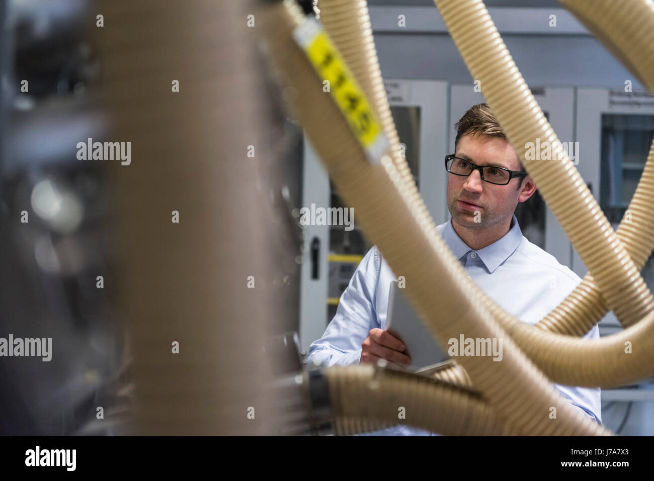 Man examining the system in factory Stock Photo - Alamy