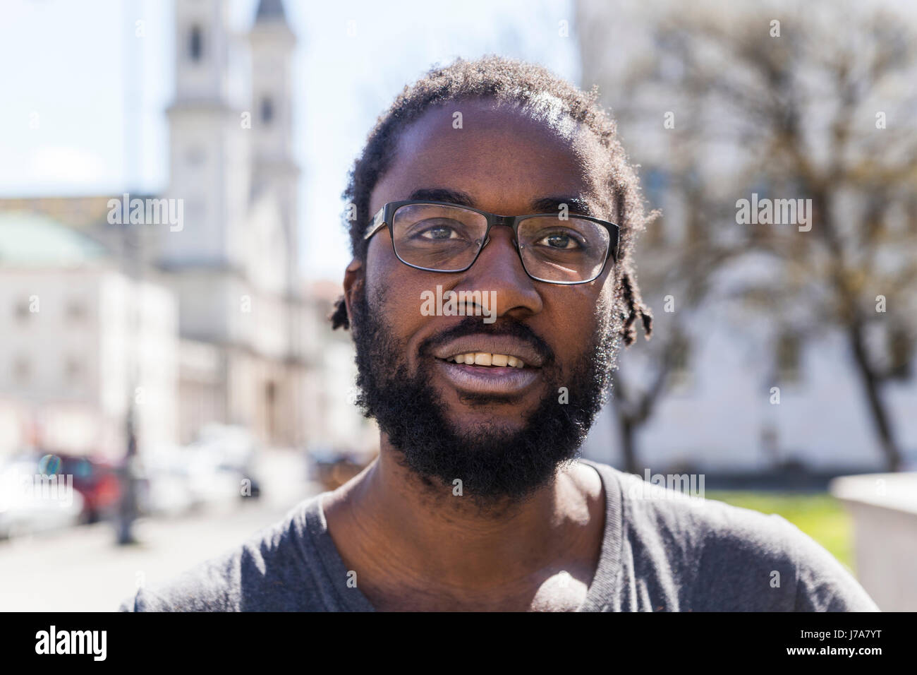 Germany, Munich, portrait of man with beard wearing glasses Stock Photo ...