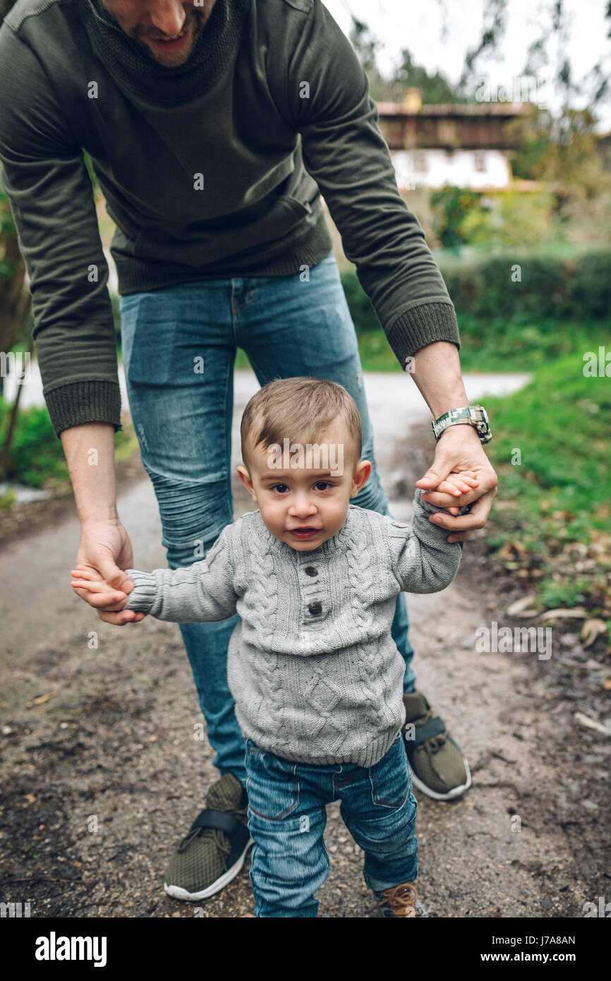 Father leading little boy on path Stock Photo - Alamy