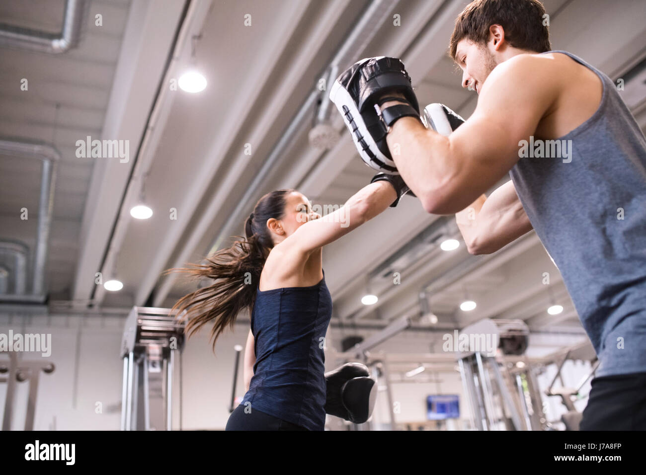 Young woman boxing with her coach Stock Photo - Alamy