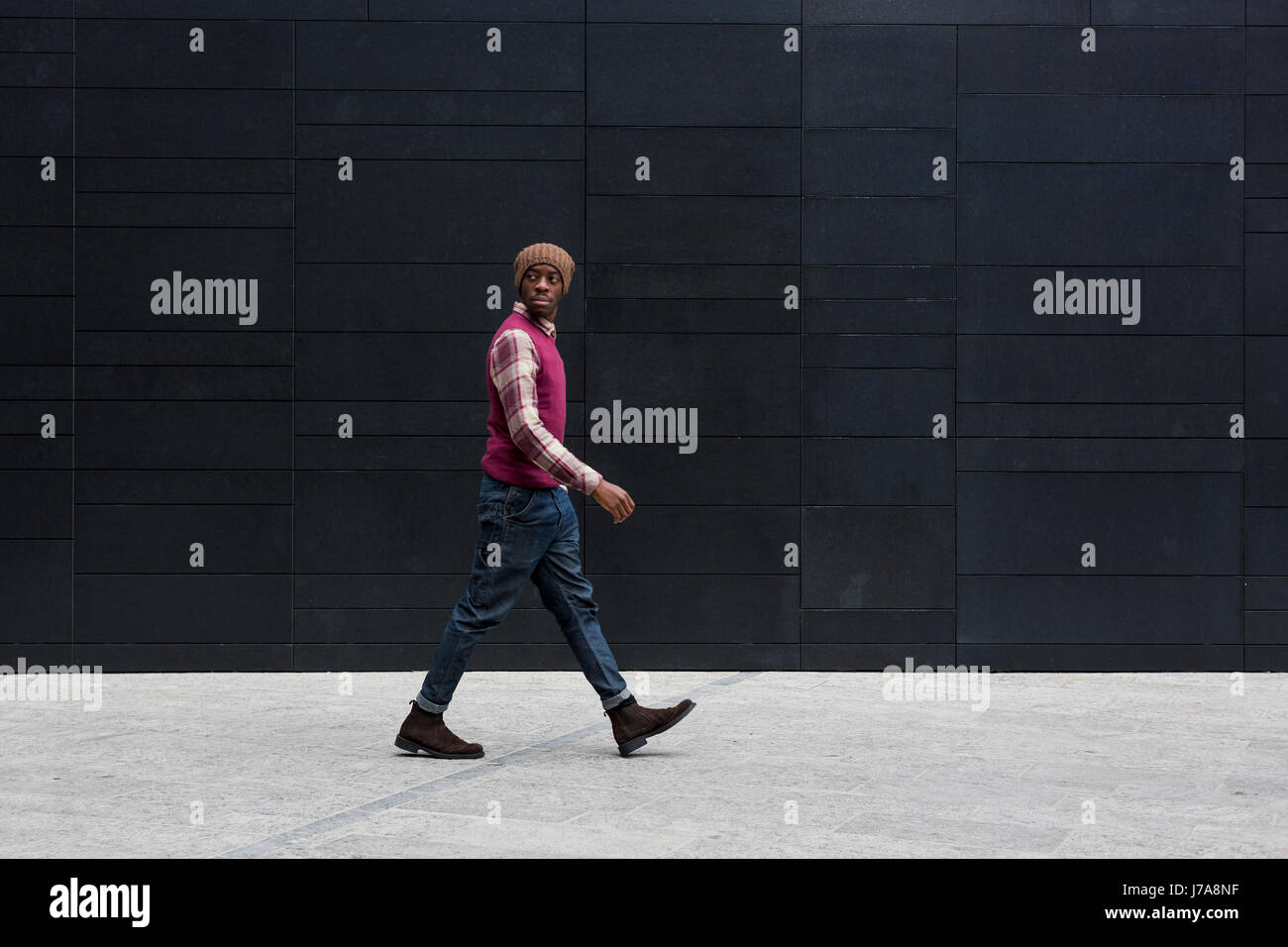 Walking man watching something Stock Photo - Alamy