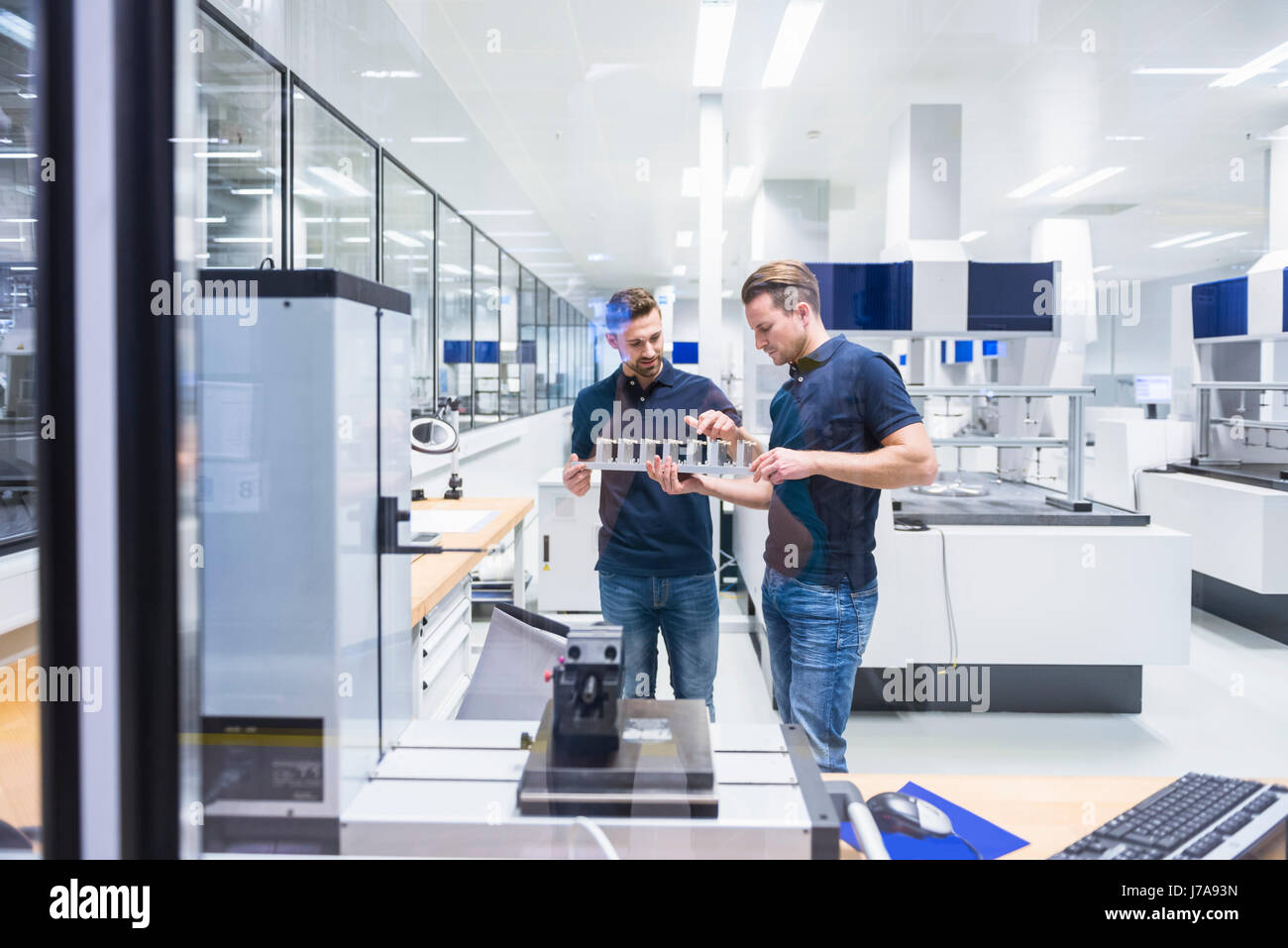 Two men in testing instrument room talking about product Stock Photo ...
