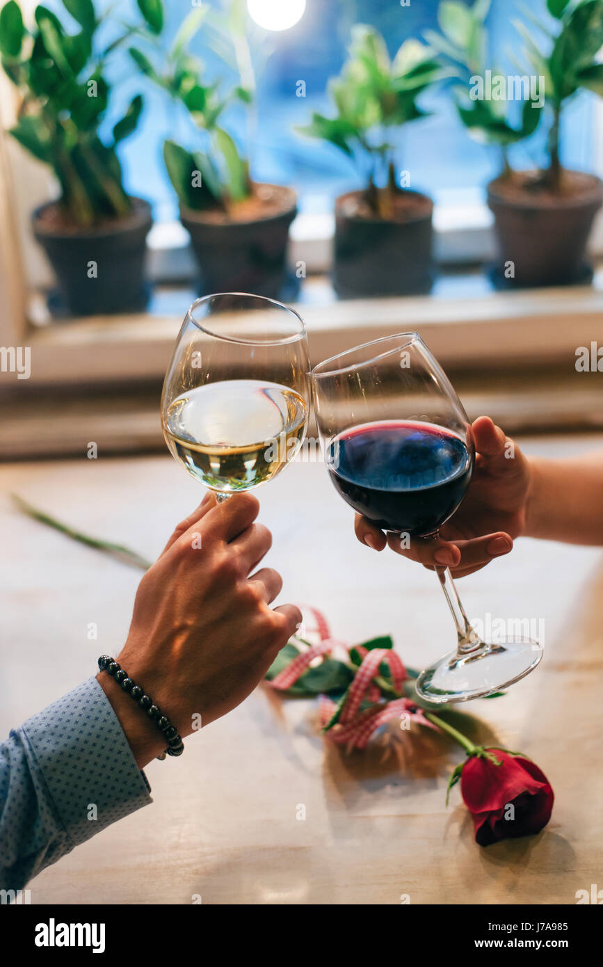 Couple toasting with wine, close-up Stock Photo - Alamy