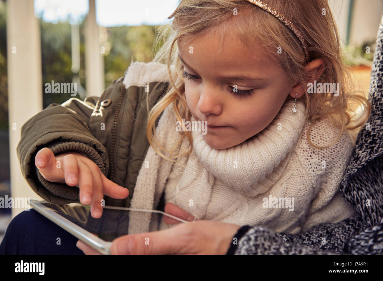 Girl with her mother using tablet Stock Photo - Alamy