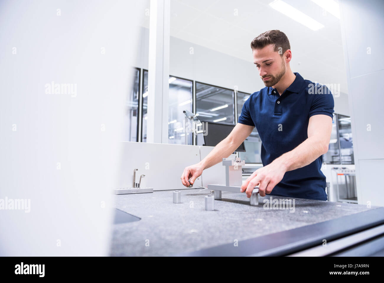 Man at a machine in testing instrument room Stock Photo - Alamy